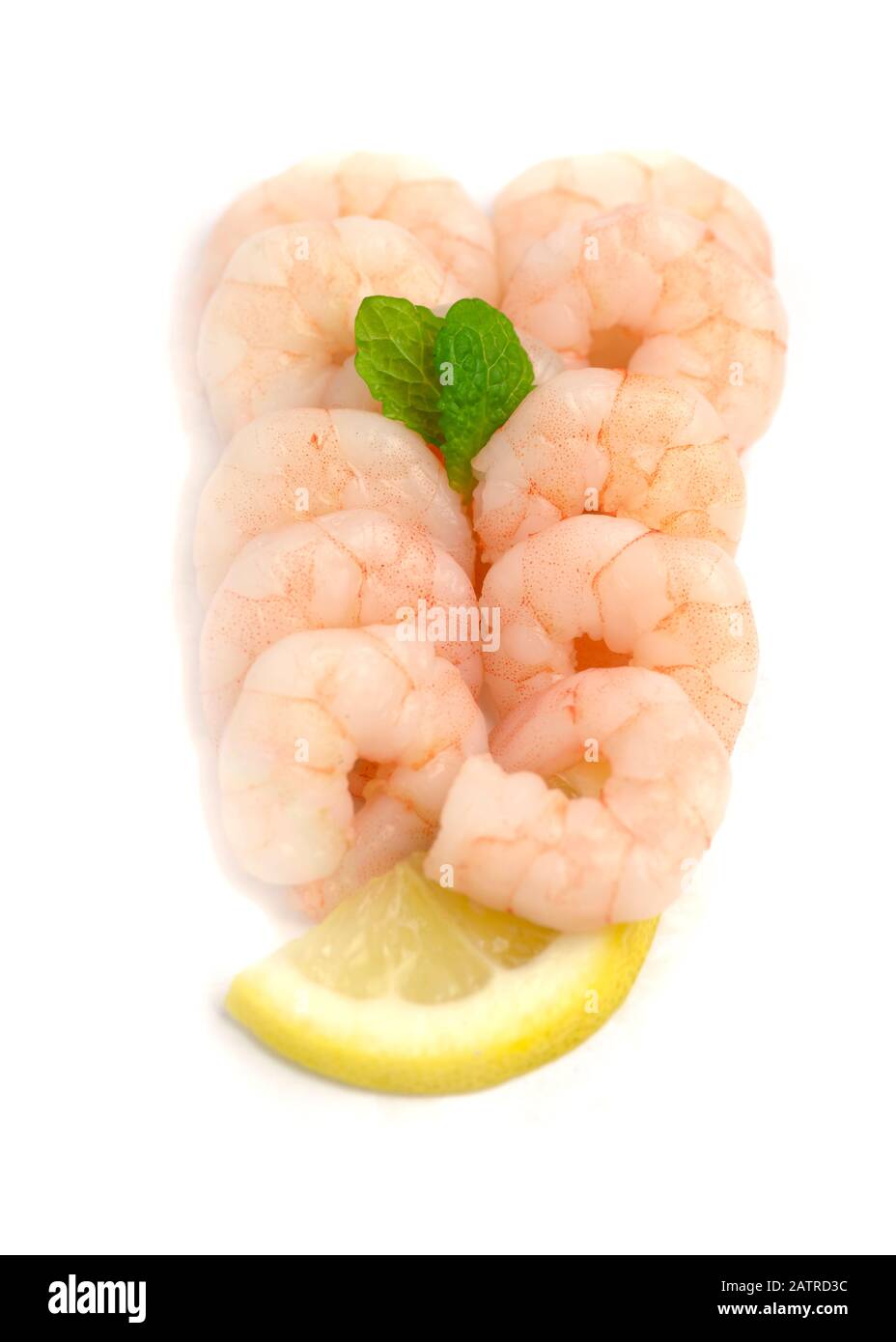 over head shoot of cooked king prawns peeled with lemon and mint on a ...