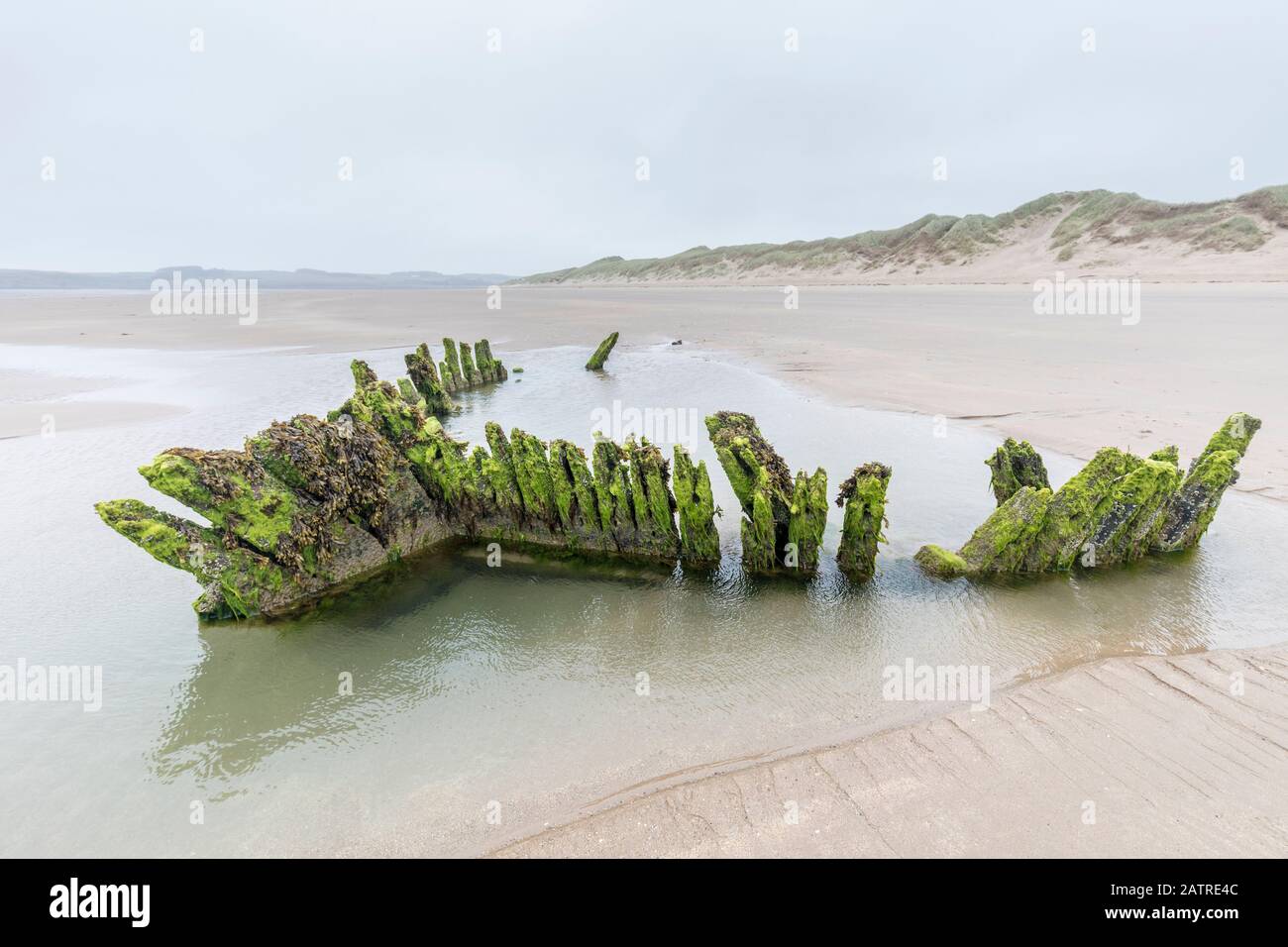 Remains of boat in Malltraeth Sands, Anglesey, Wales, UK Stock Photo ...