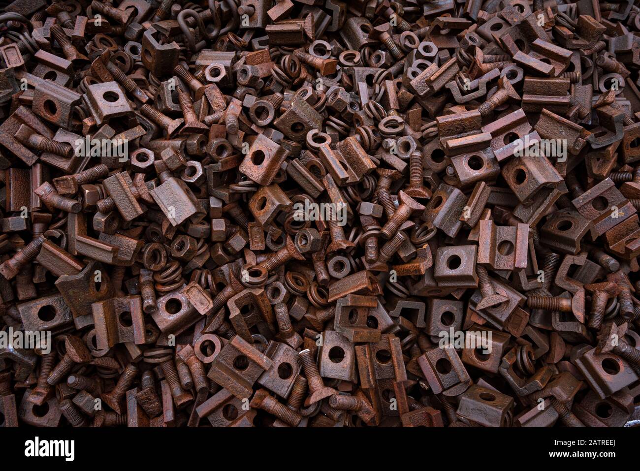 Old metal collected for recycling. Pile of rusty iron screws and screw ...
