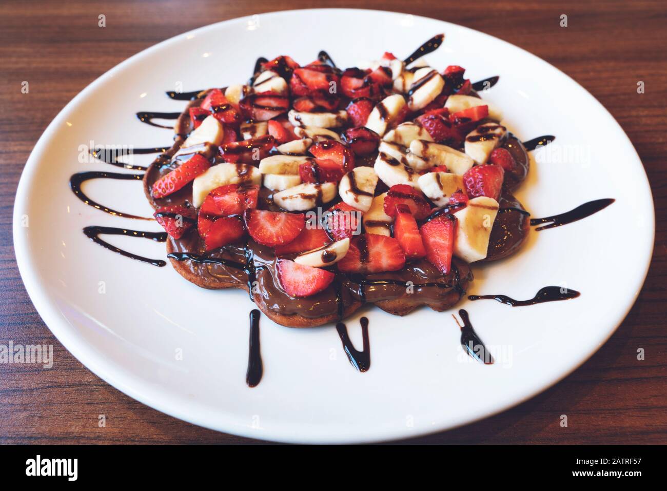 Traditional Belgian dessert - waffle with strawberry, banana and cream ...