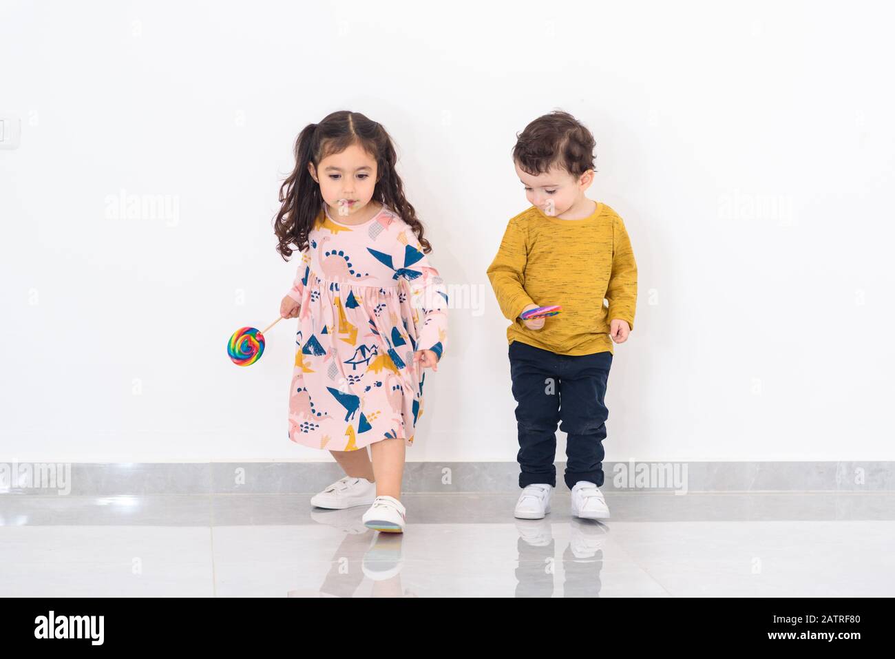 Two Young Children Running Towards Camera In Home Stock Photo - Alamy