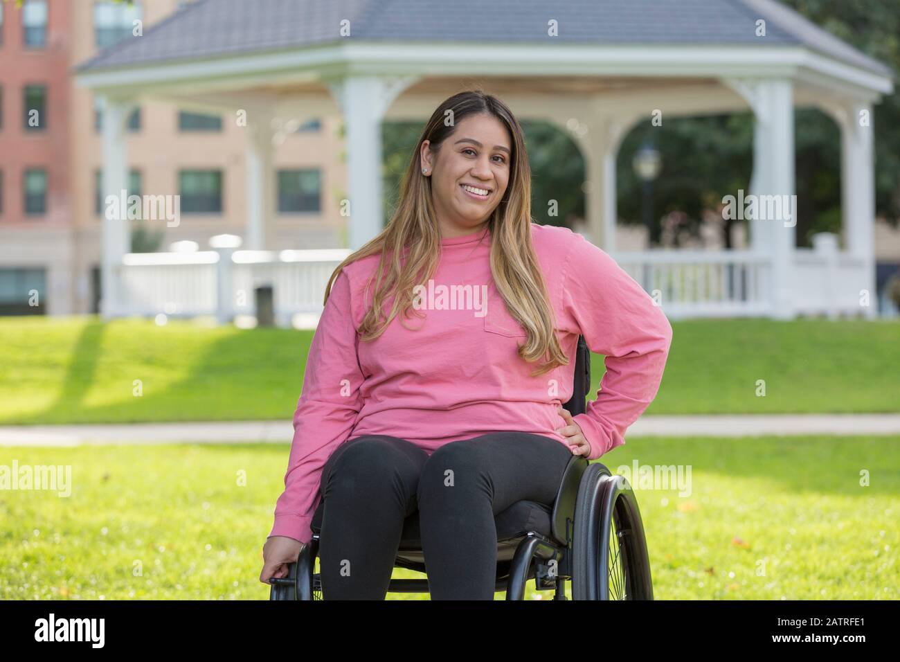 Woman with Spinal Cord Injury sitting in wheelchair in a park Stock ...