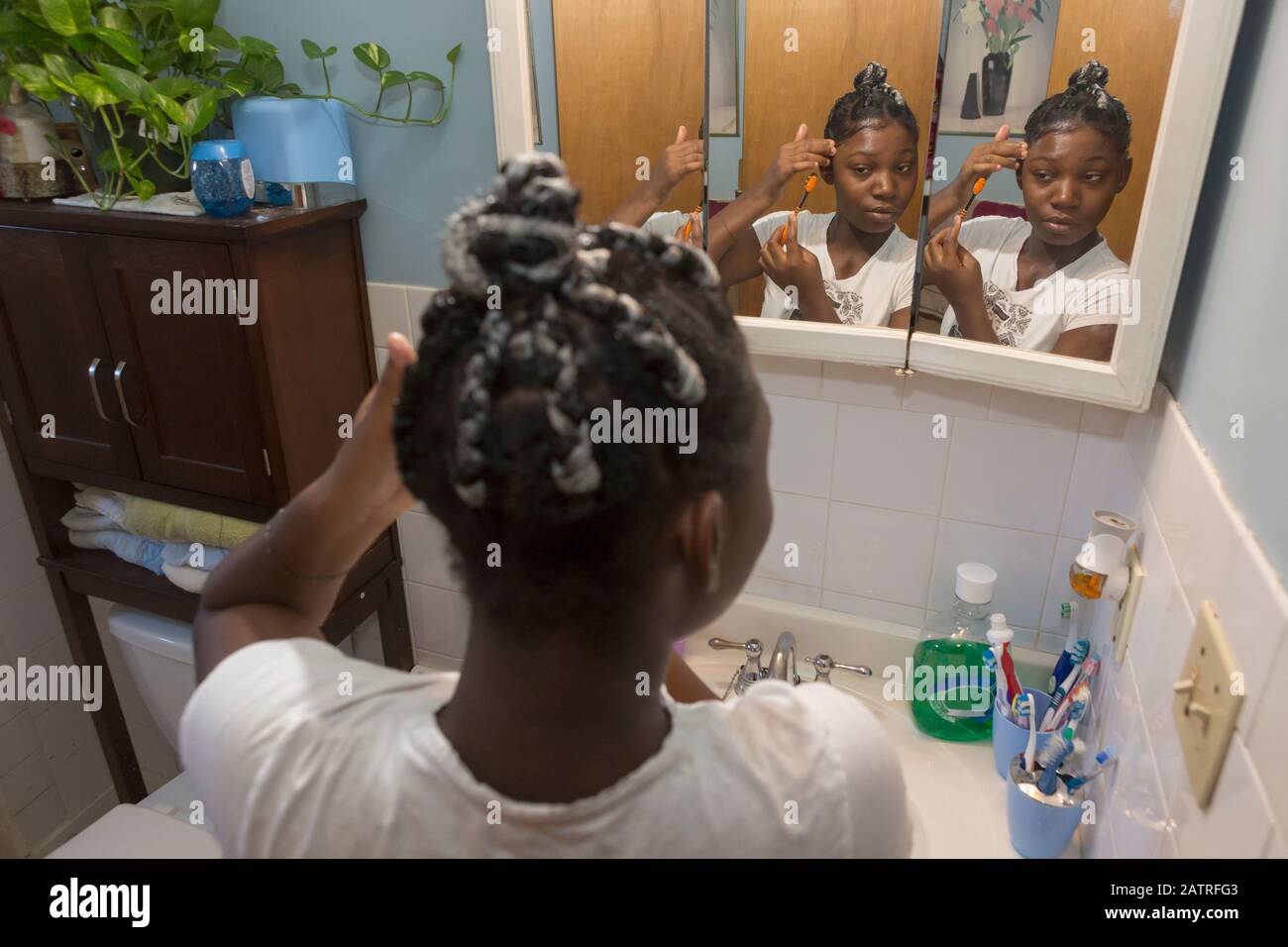 Teen suffering from Bipolar Disorder doing her hair Stock Photo - Alamy