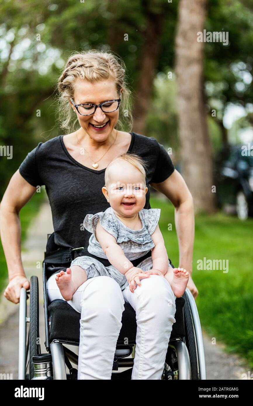 Girl pushing wheelchair hi-res stock photography and images - Alamy
