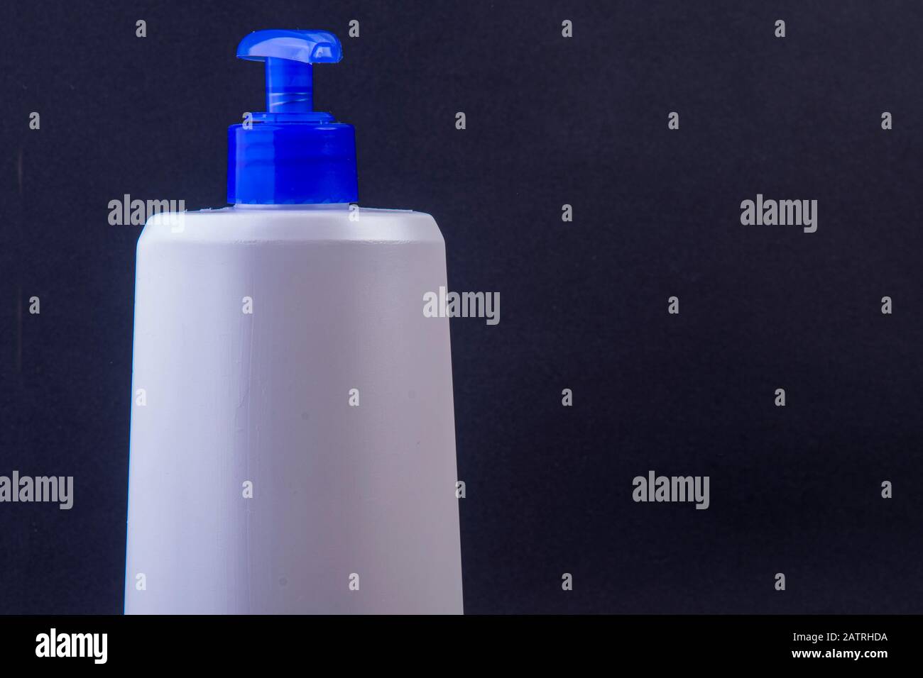 empty cream bottle with dispenser on black Stock Photo - Alamy
