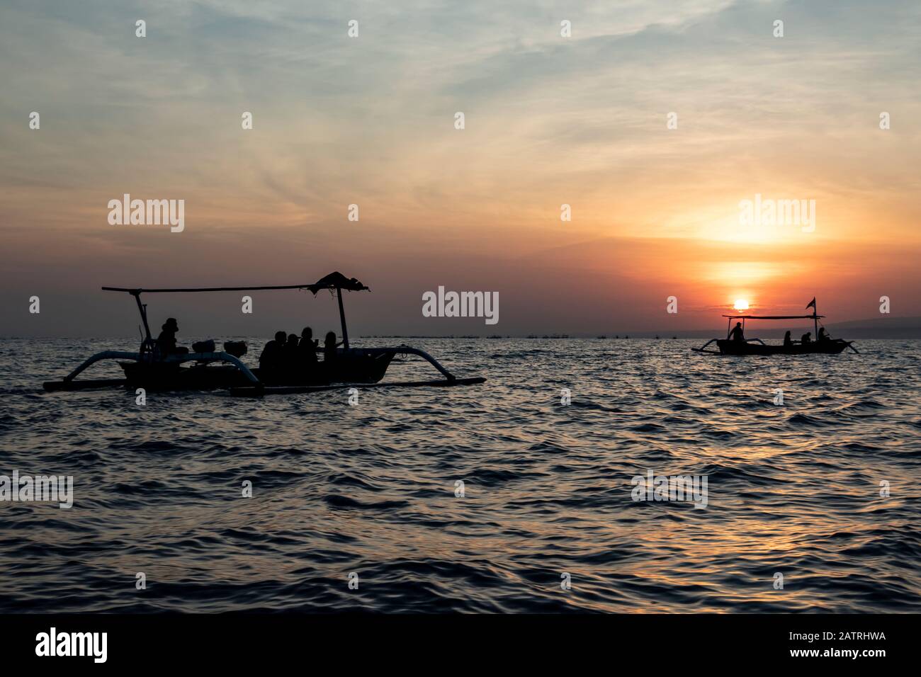 Indonesian jukung, traditional wooden outrigger canoe at sunrise ...