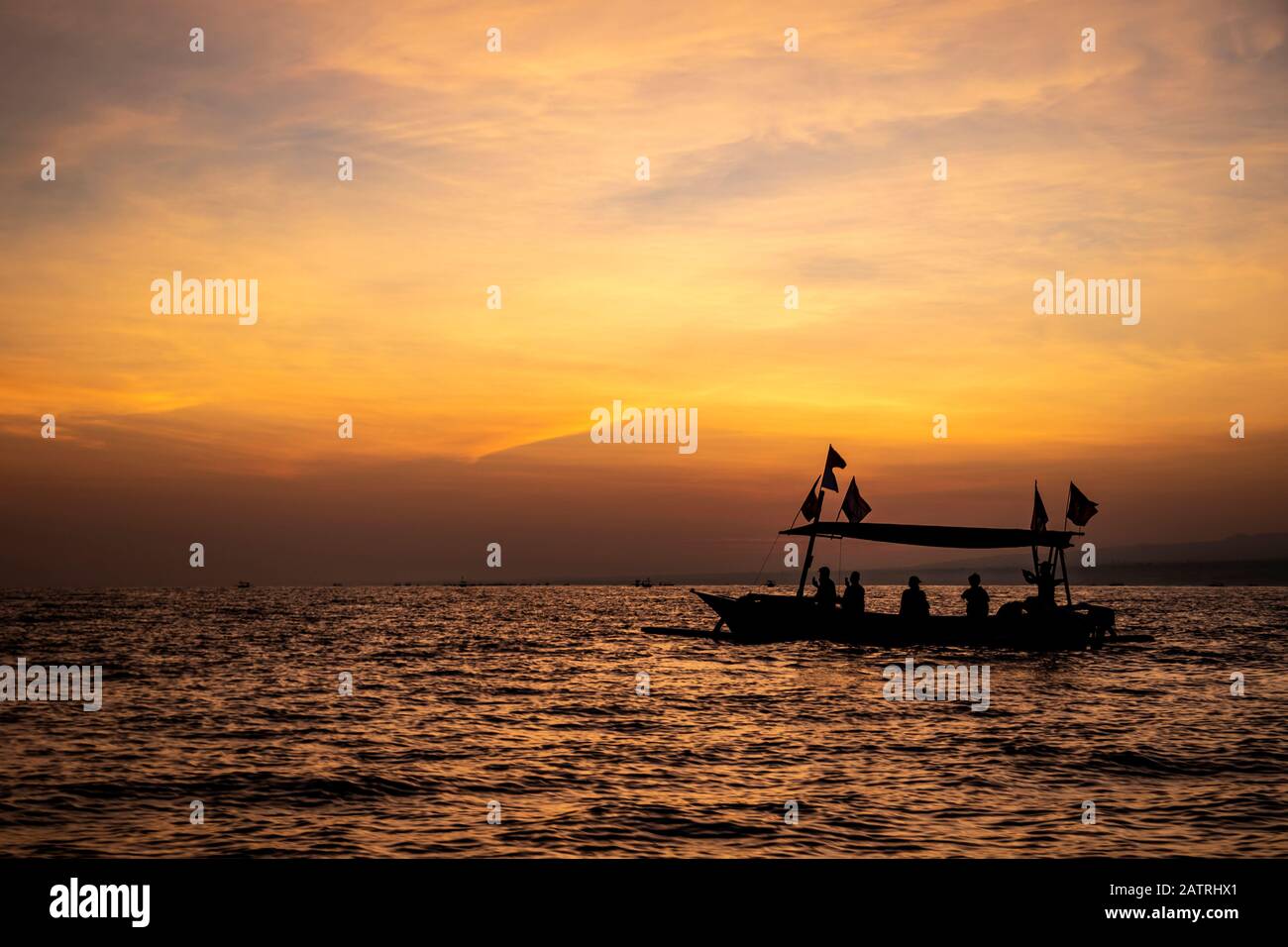 Indonesian jukung, traditional wooden outrigger canoe at sunrise ...