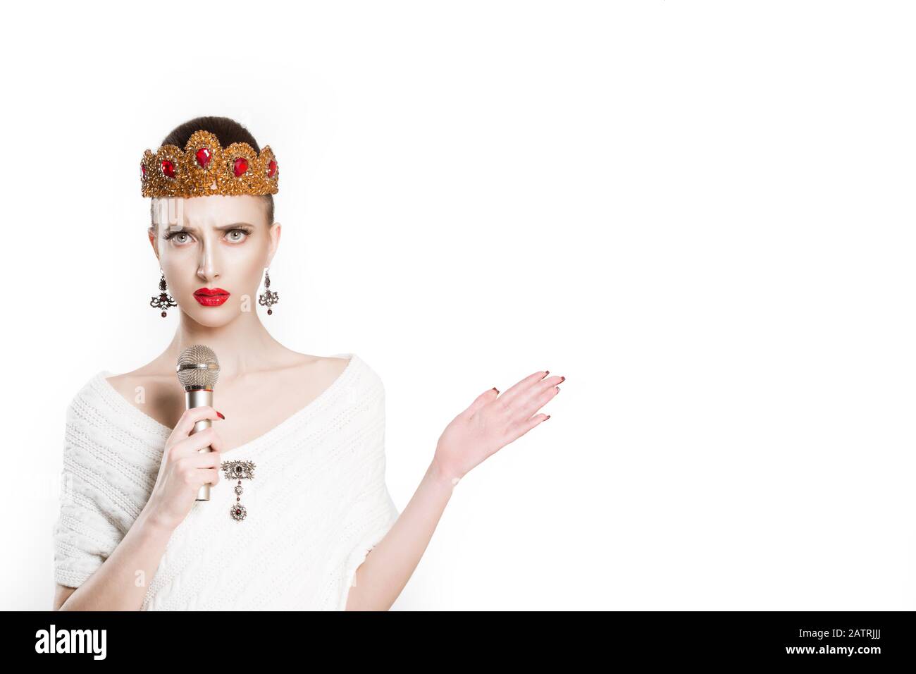 Frustrated beauty queen speaking on microphone gesturing anger with ...