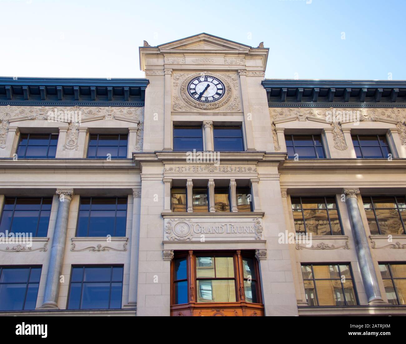 Clock on facade of old office building Stock Photo - Alamy