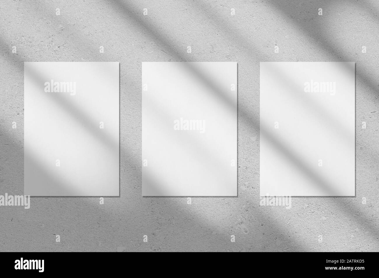 Three empty white vertical rectangle poster or business card mockups ...