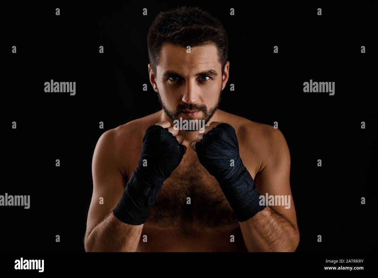 Muscular boxing man ready to fight on black background Stock Photo - Alamy