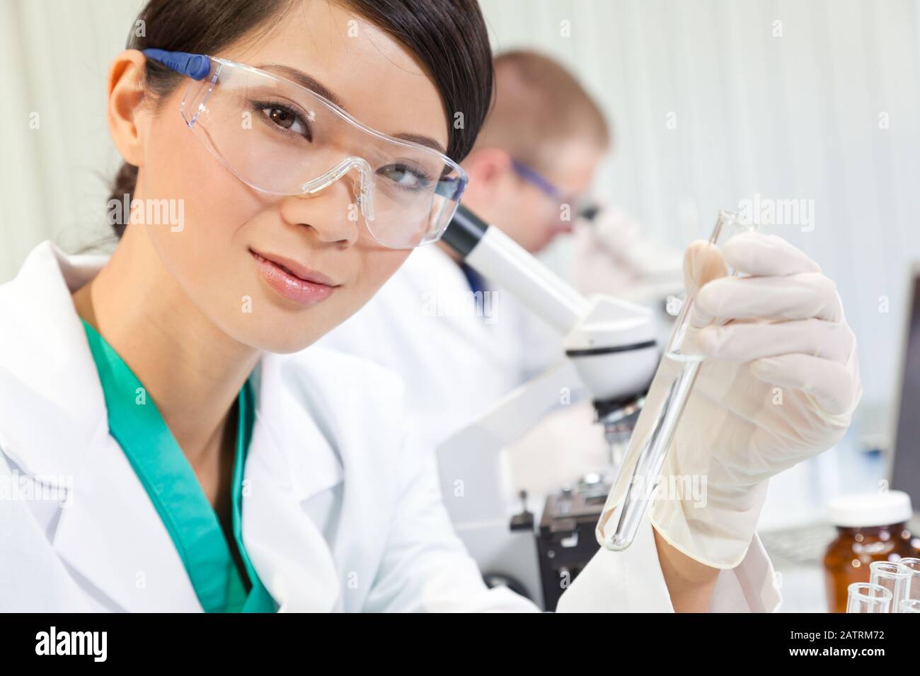 A Chinese Asian female medical or scientific researcher or doctor using ...