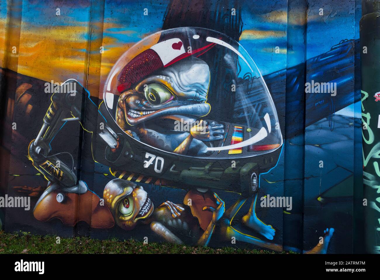 Beautiful outdoor graffiti art with an alien in a space vehicle at the ...