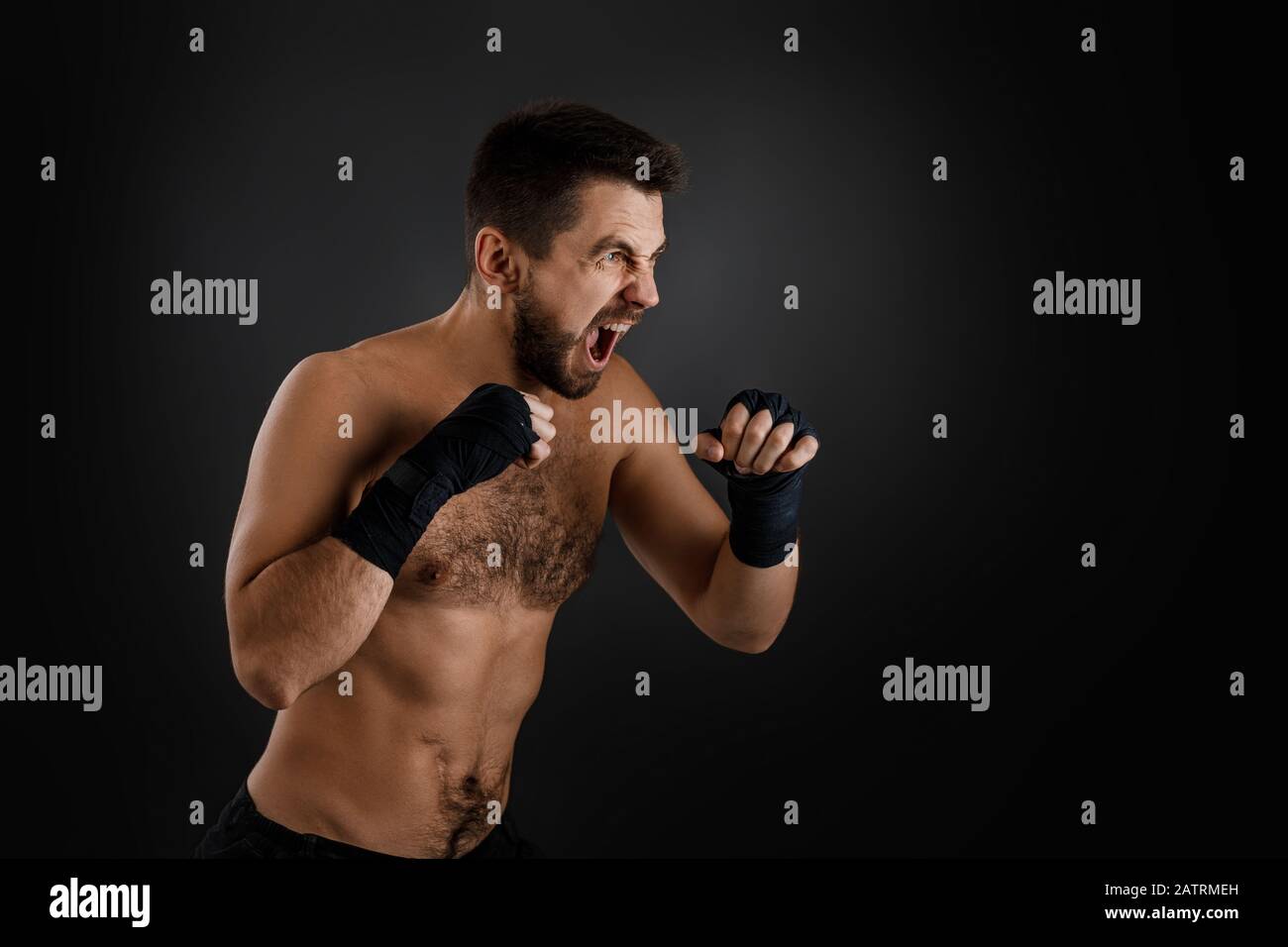 Sportsman boxer throwing a fierce and powerful punch. muscular man on ...