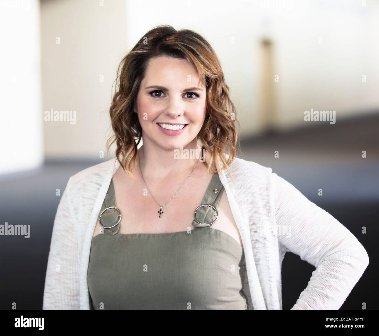 A Christian woman who is a pastor, posing for a picture in a hallway at ...