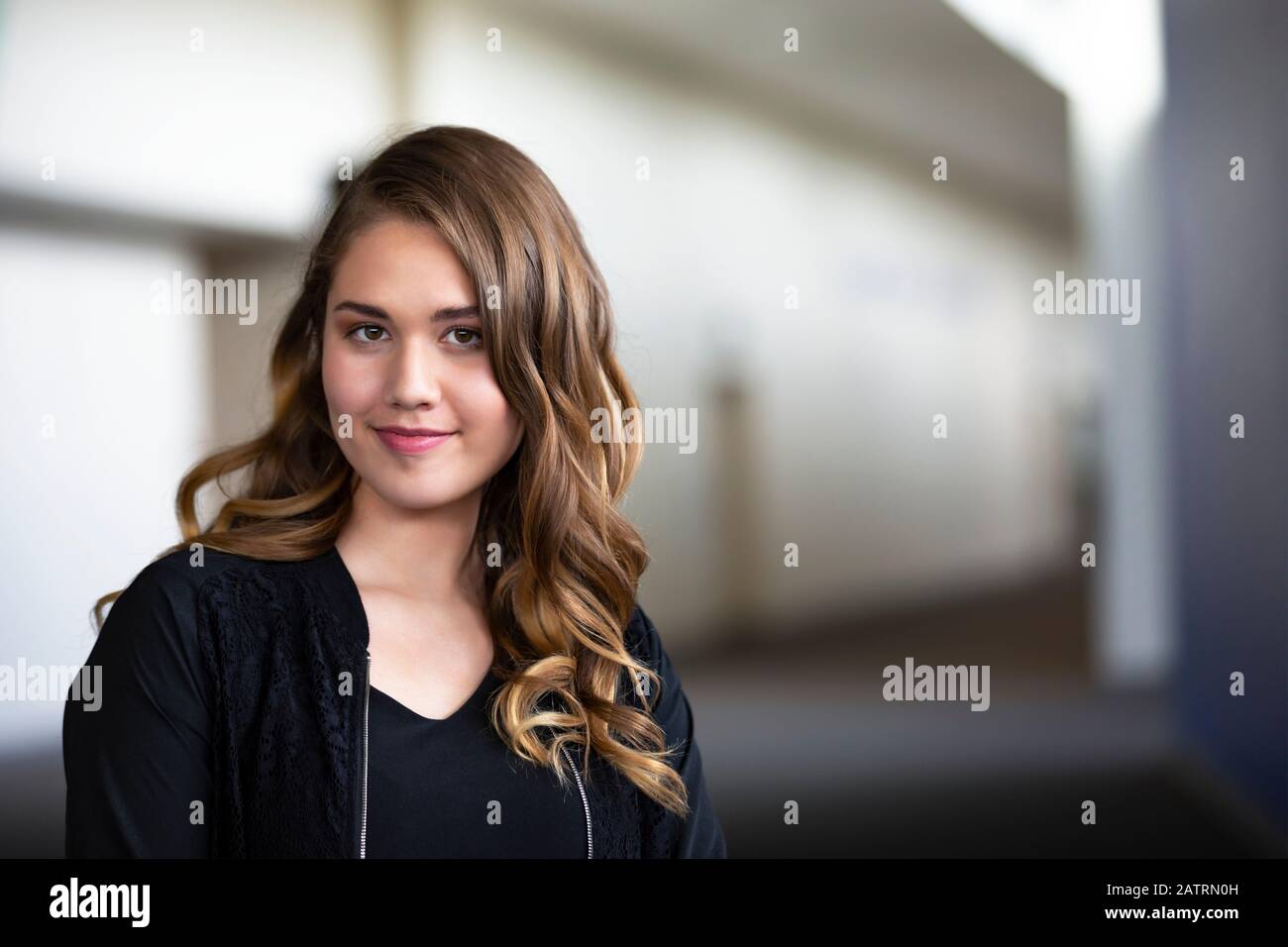 A young woman posing for a picture in a hallway: Edmonton, Alberta ...