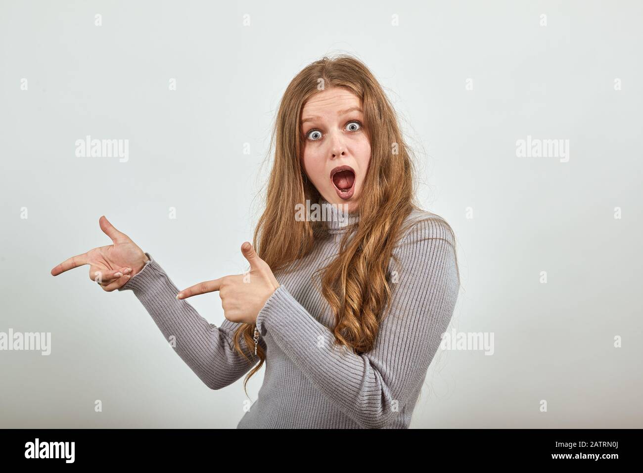 Surprised woman shows finger direction hi-res stock photography and ...