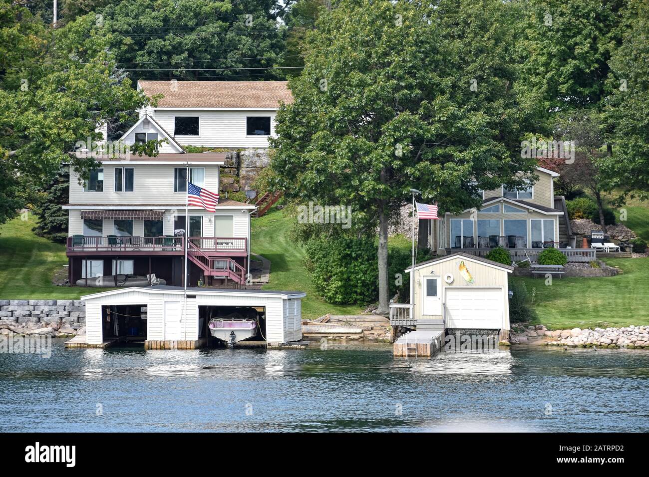 Different buildings in a grassy area on the coast of a lake during ...