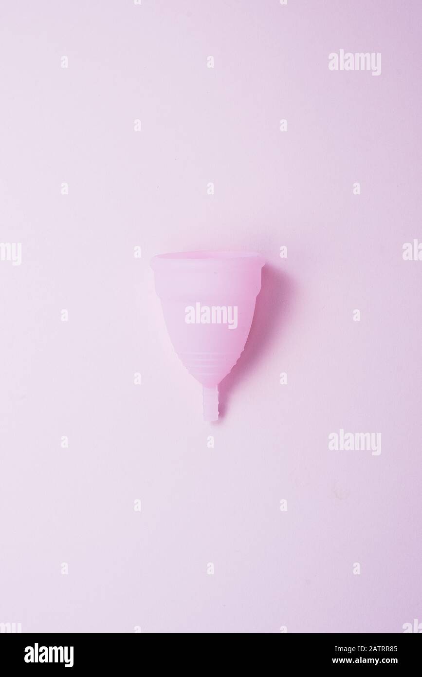 Pink menstrual cup on a pastel background. Vertical photo. Trendy ...