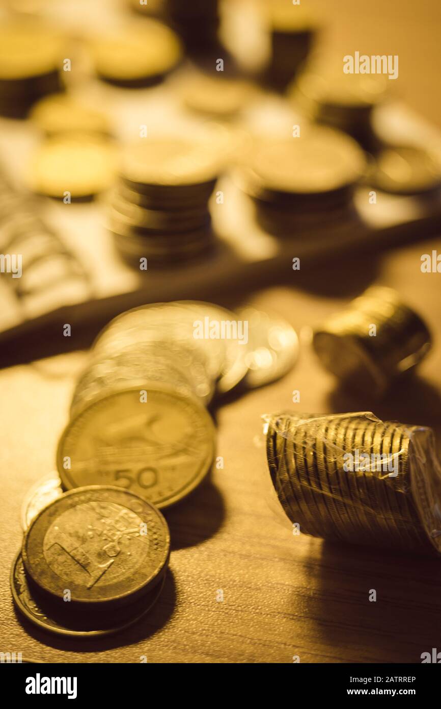 Collection of golden metal money on the table Stock Photo - Alamy