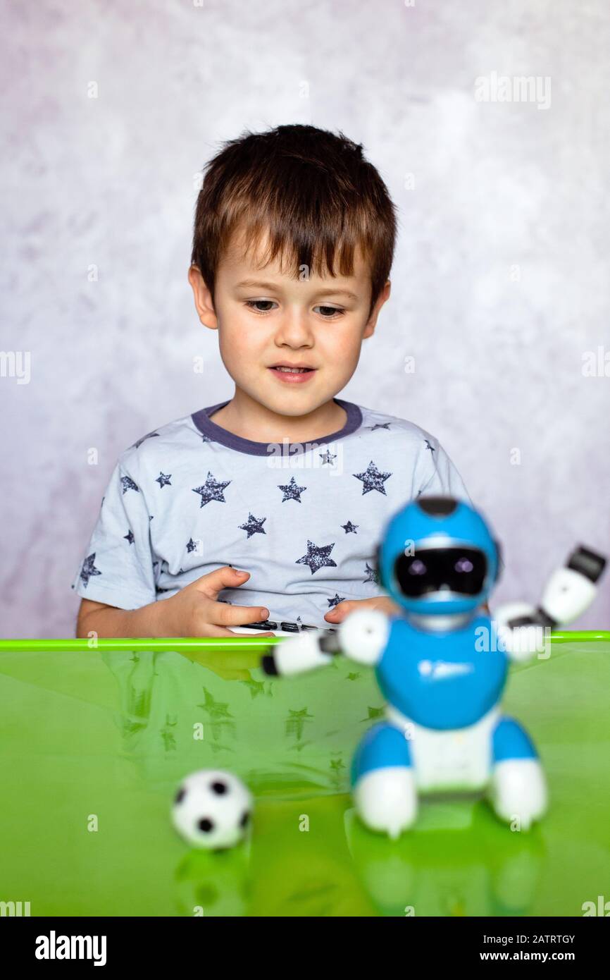 Little boy is playing with robot. Robot for children. Smart toy Stock ...