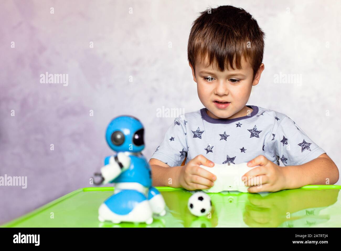Little boy is playing with robot. Robot for children. Smart toy Stock ...