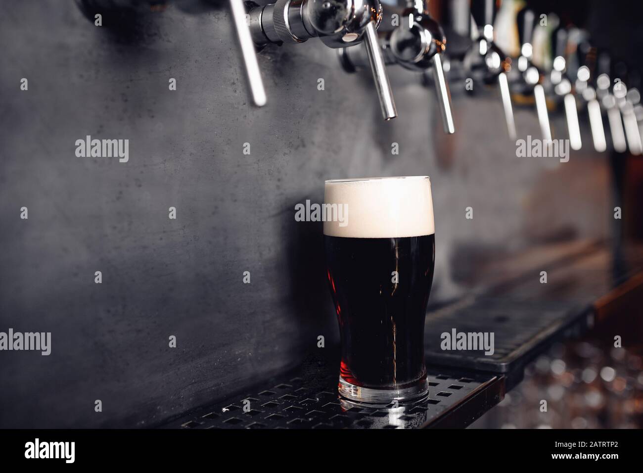 Beer taps raw in pub. Selective focus, dark background Stock Photo - Alamy