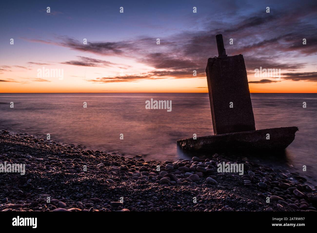 Pylon in the sea in a beautiful sunrise Stock Photo - Alamy