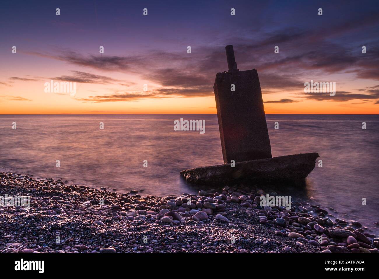 Pylon in the sea in a beautiful sunrise Stock Photo - Alamy