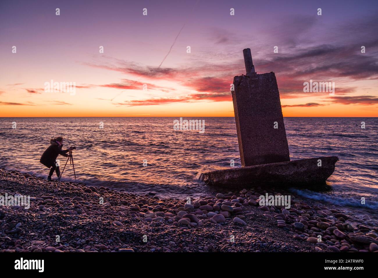 Pylon in the sea in a beautiful sunrise Stock Photo - Alamy