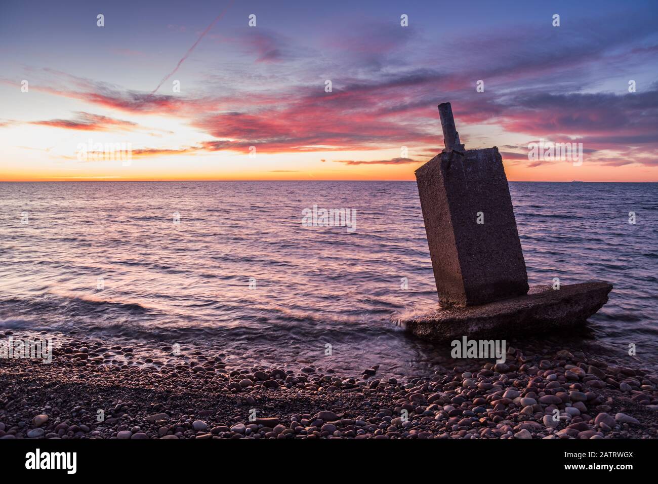 Pylon in the sea in a beautiful sunrise Stock Photo - Alamy