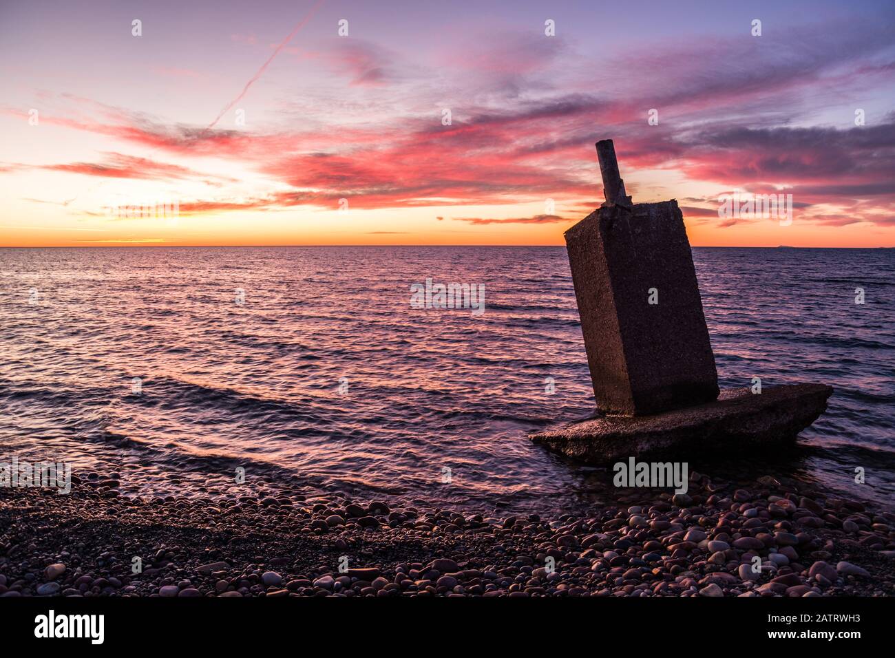 Pylon in the sea in a beautiful sunrise Stock Photo - Alamy