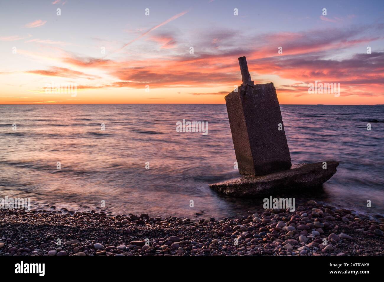 Pylon in the sea in a beautiful sunrise Stock Photo - Alamy