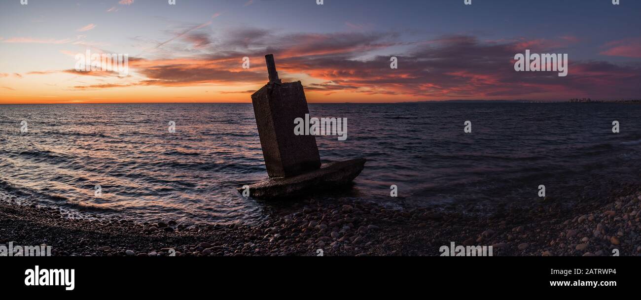 Pylon in the sea in a beautiful sunrise Stock Photo - Alamy