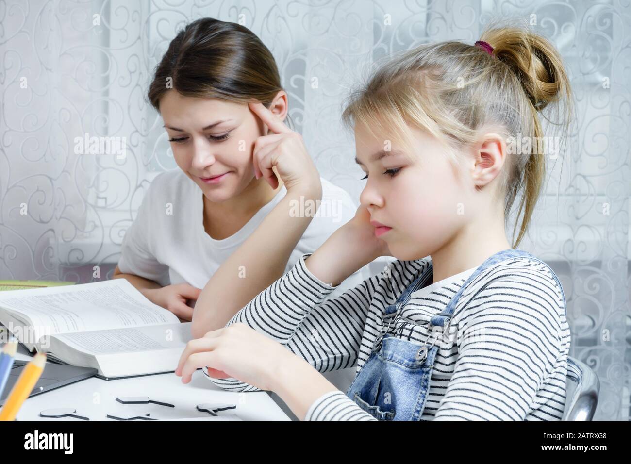 Mother and daughter doing homework together Stock Photo - Alamy