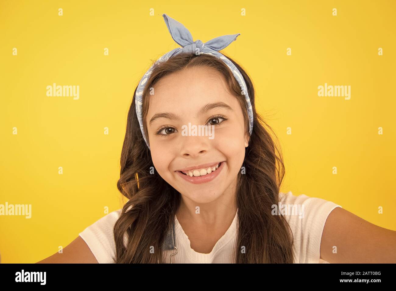 Smile like a model. Adorable small child with happy smile on yellow ...