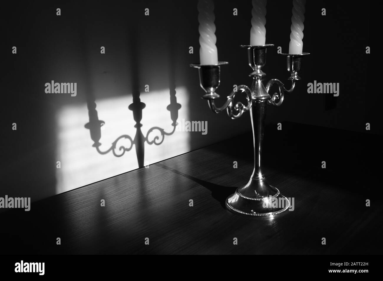Vintage candlestick with three candles, shadow reflection on the wall ...