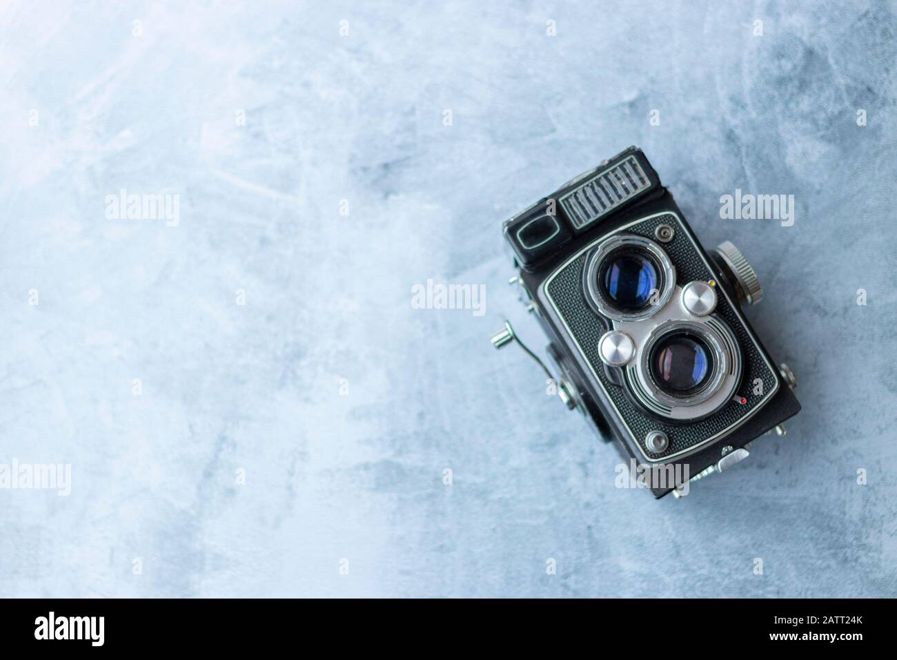 Old medium format camera of black color next to current laptop, on ...