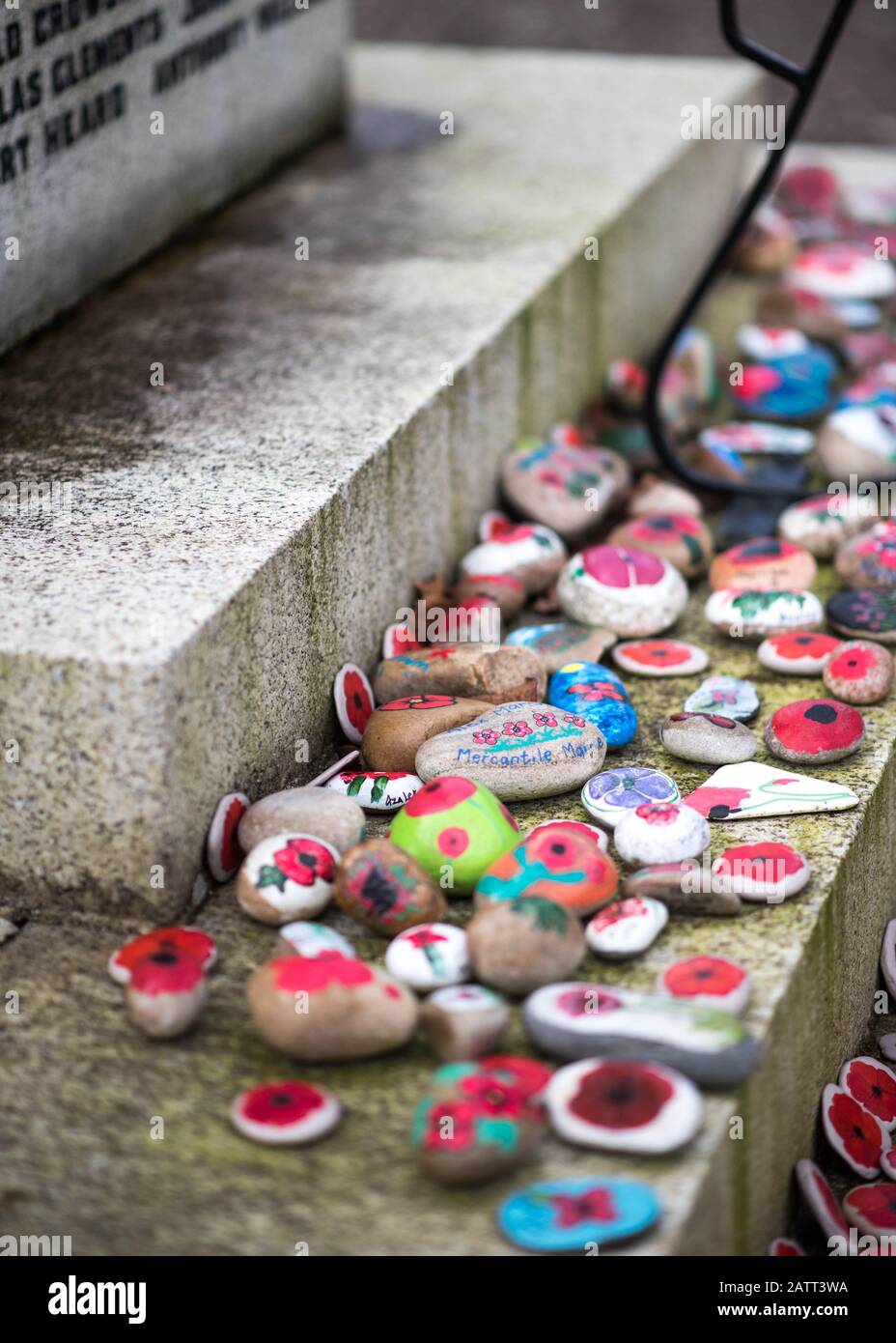 Painted rocks depicting Poppy flowers laid on the war memorial in ...