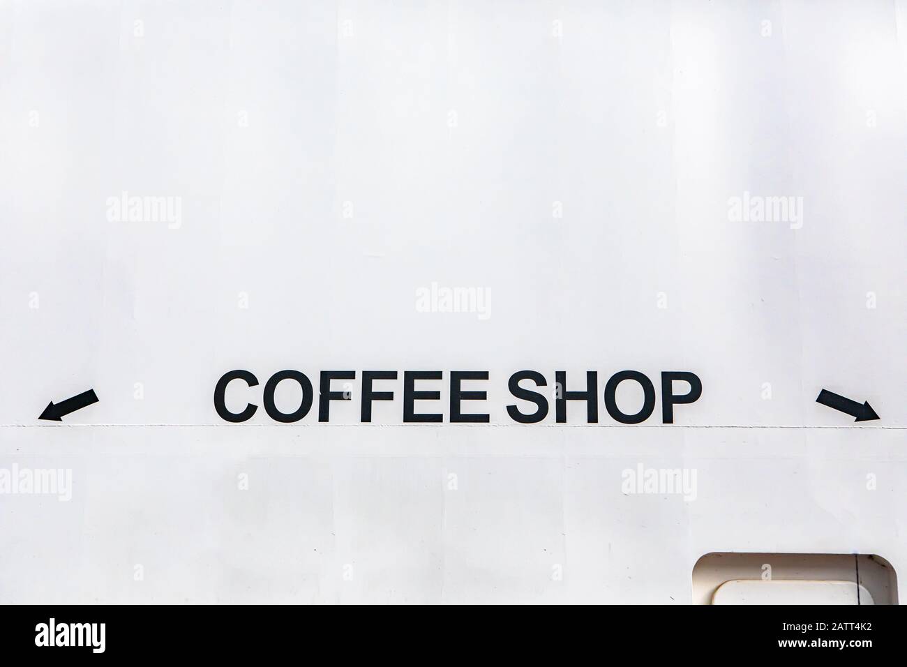 Coffee shop sign with black letters painted on white background, on a ...