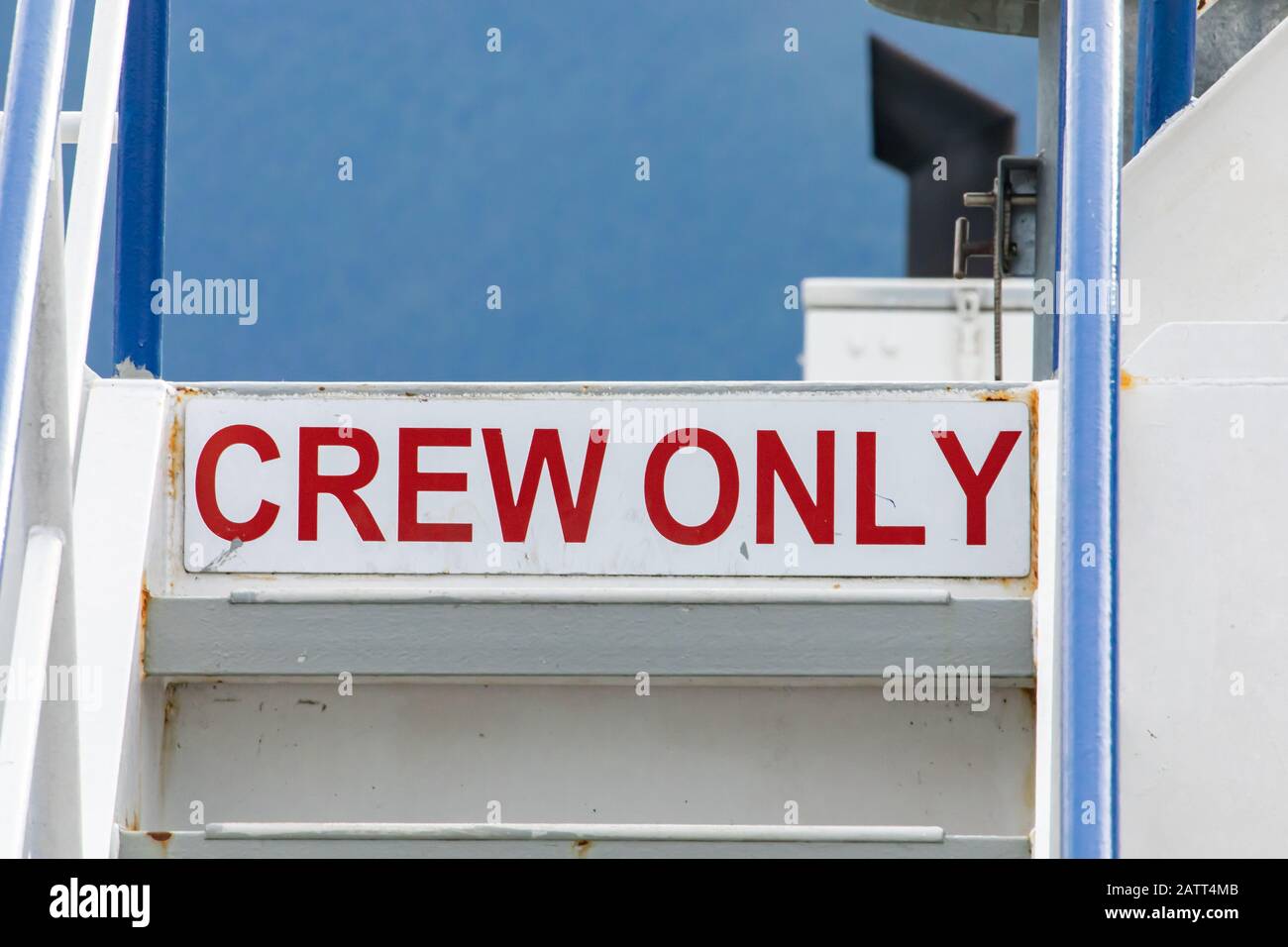 Red lettered signboard on white background saying Crew Only. Warning ...