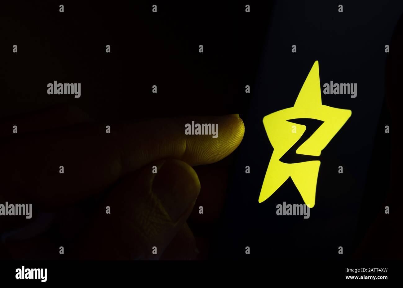 Qzone logo on the dark sensor screen and a finger touching it. Qzone is ...