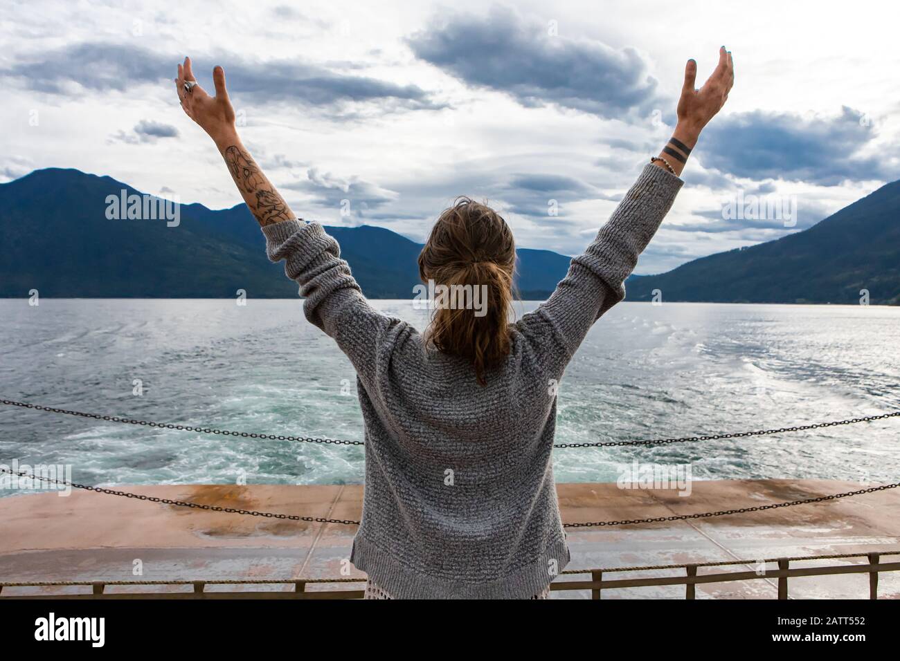 Close up from behind of a young lady on the deck of a passenger ...