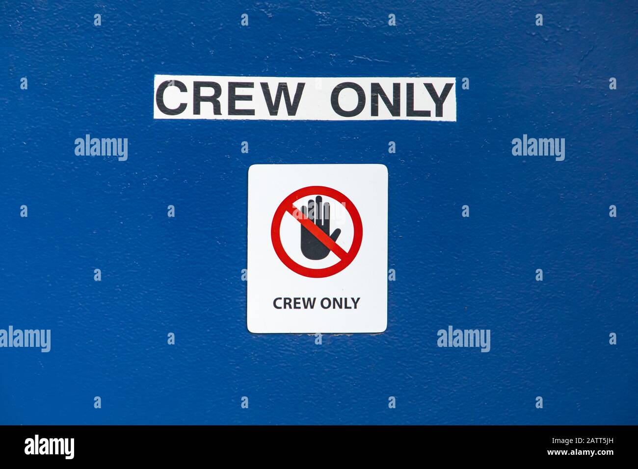 Black lettered signboard on blue background saying Crew Only. Warning ...