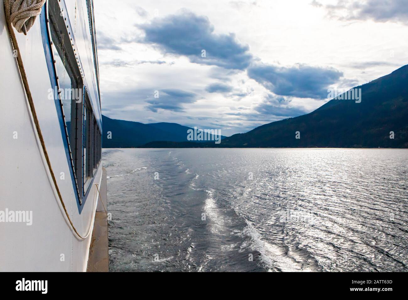 Leaning out from the deck of a ferryboat in a canadian lake. Looking ...