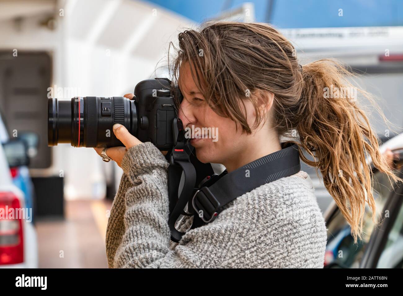 Young woman photographer shot from behind while taking pictures from ...