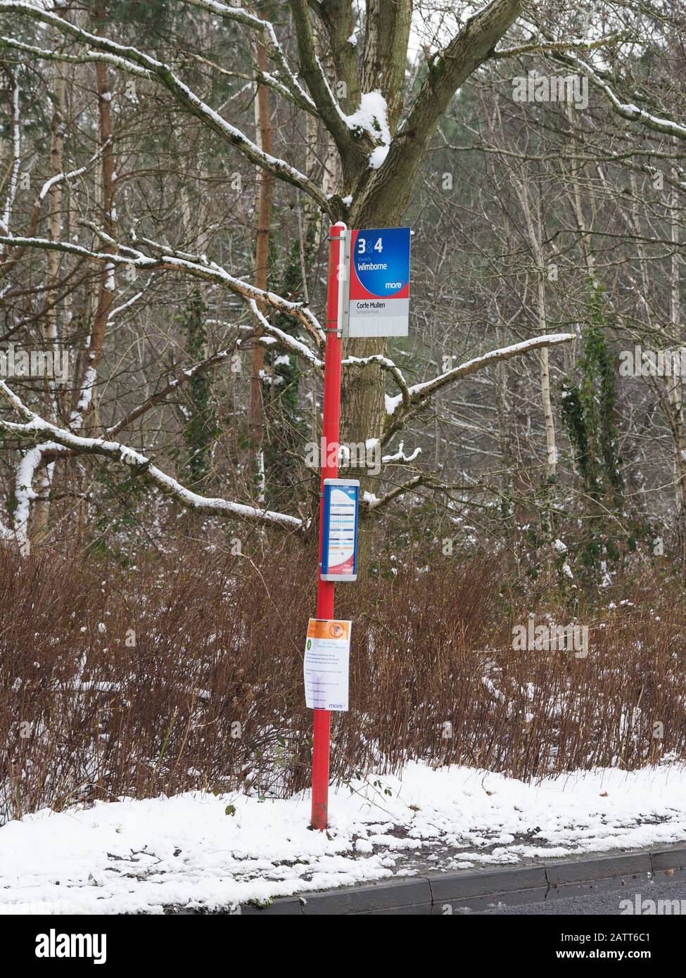 a red painted bus stop pole and flag in the snow Stock Photo - Alamy