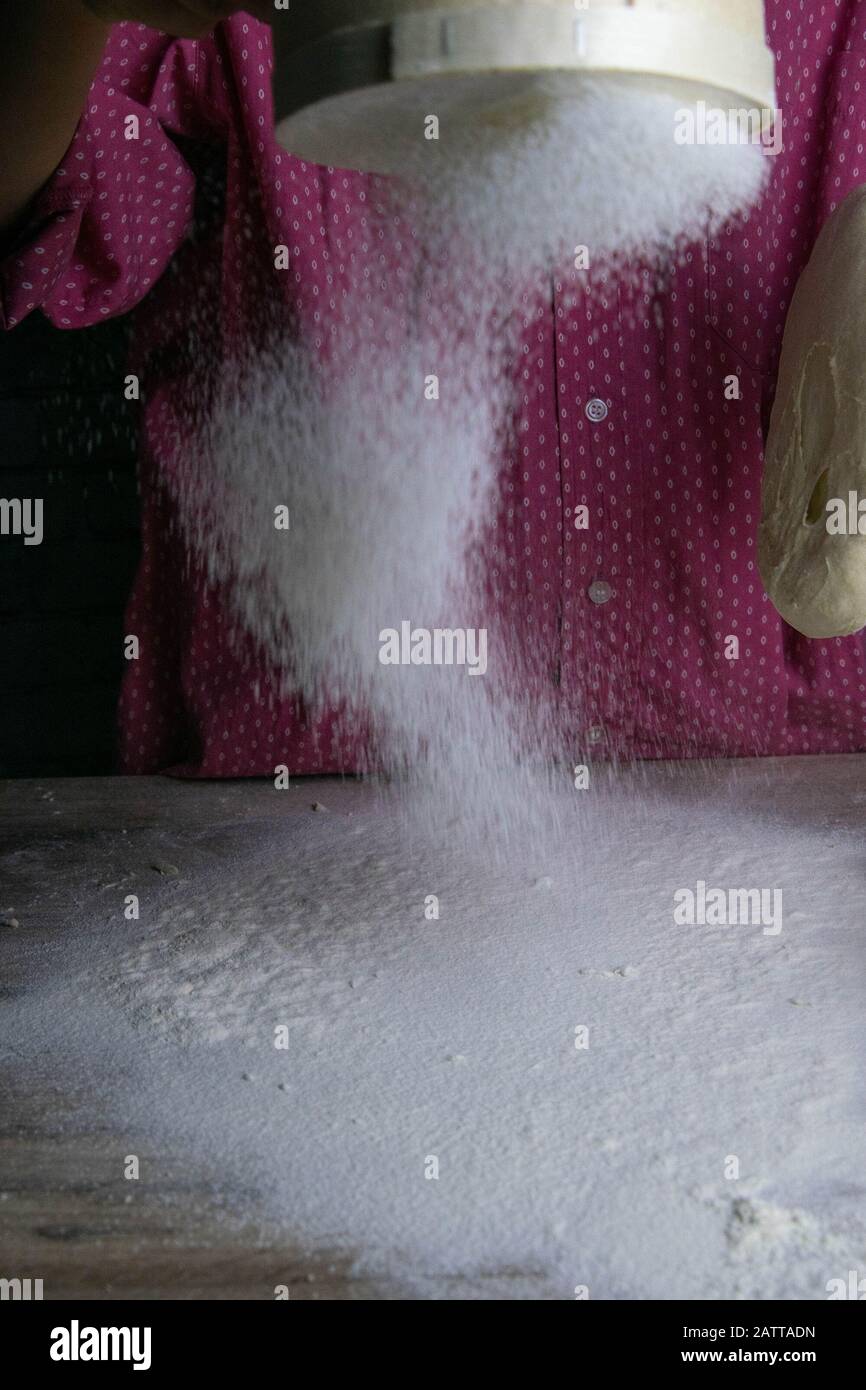 It's full of flour, women's hands sprinkle the table with flour ...