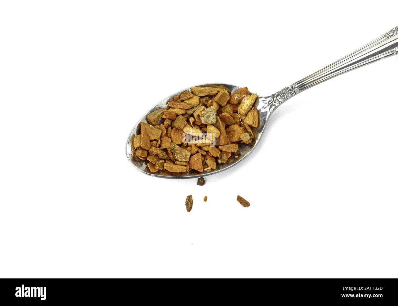 Indian chai tea, cinamon and ginger in a metal spoon isolated on white ...