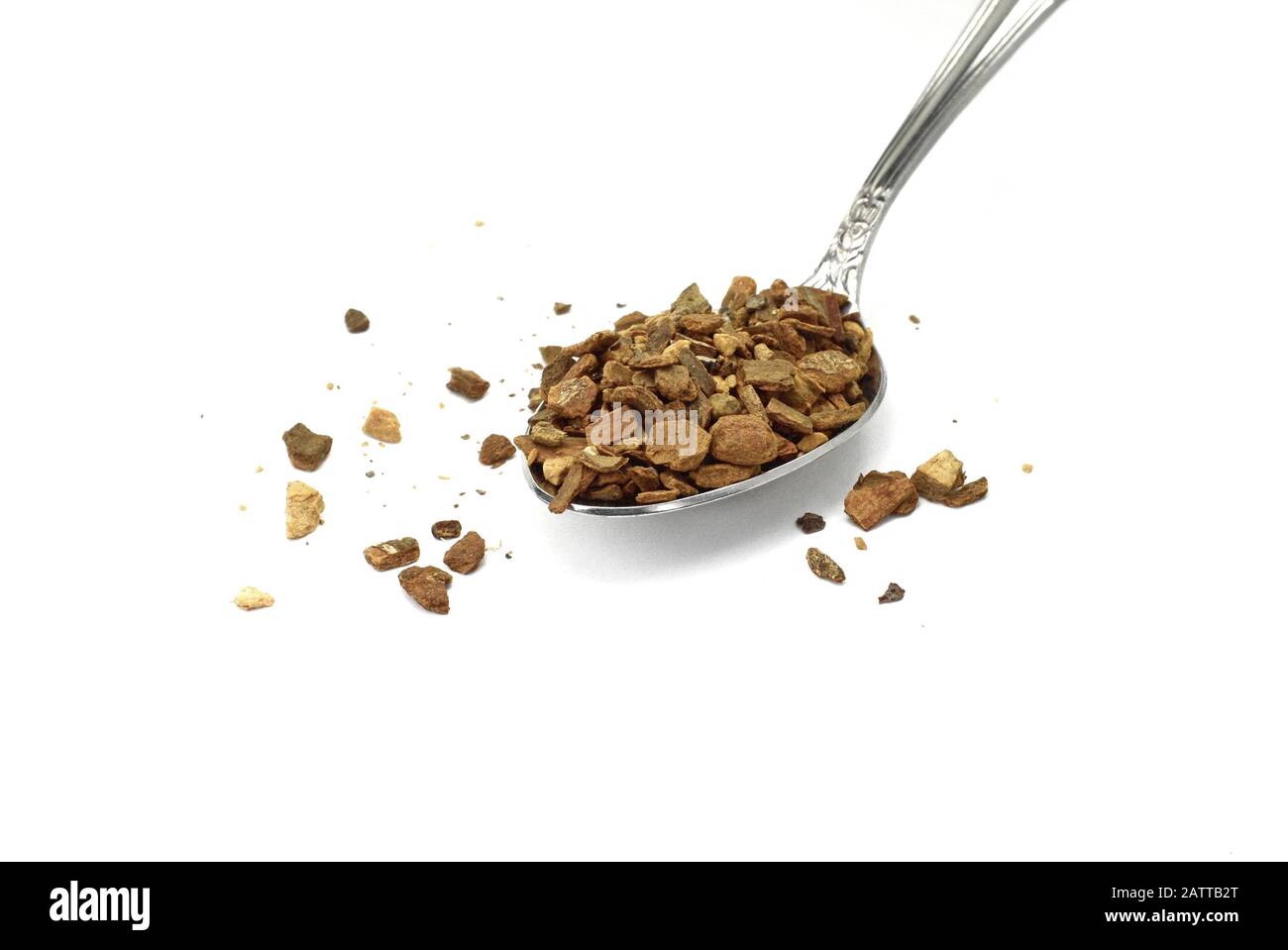 Indian chai tea, cinamon and ginger in a metal spoon isolated on white ...